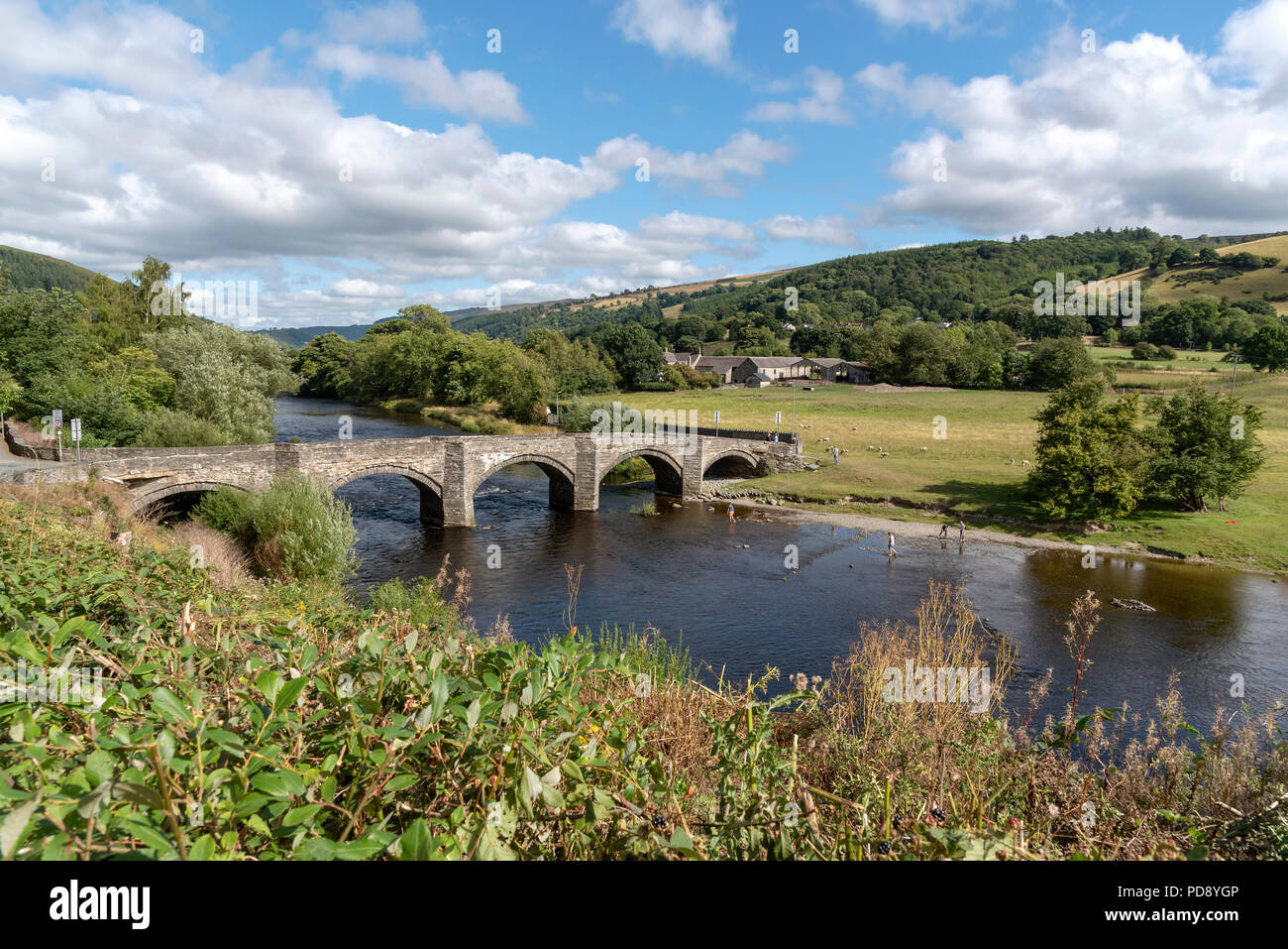 An old stone arched bridge over The River Dee flowing through the Vale ...