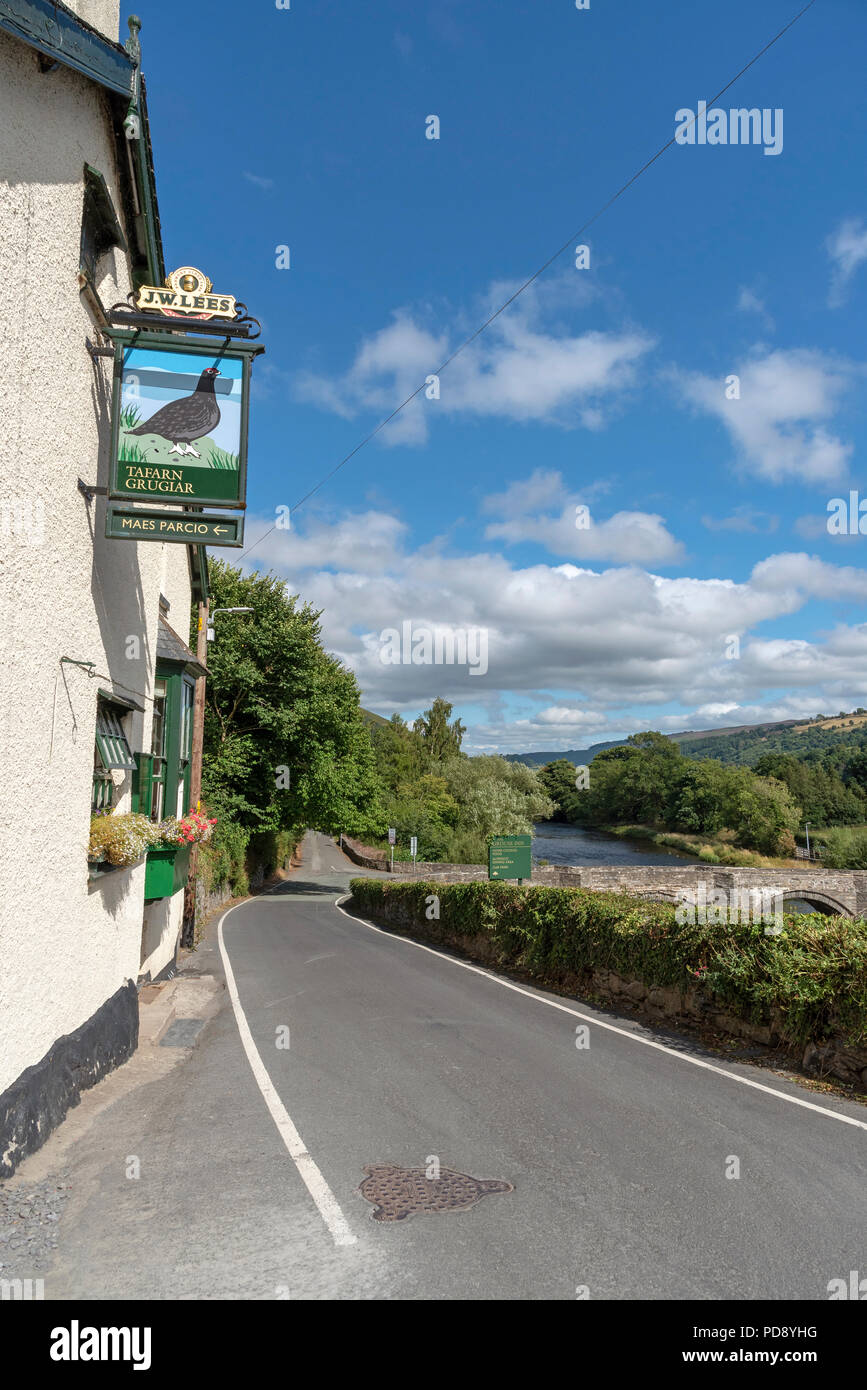 The Grouse Inn and an old stone arched bridge over The River Dee ...