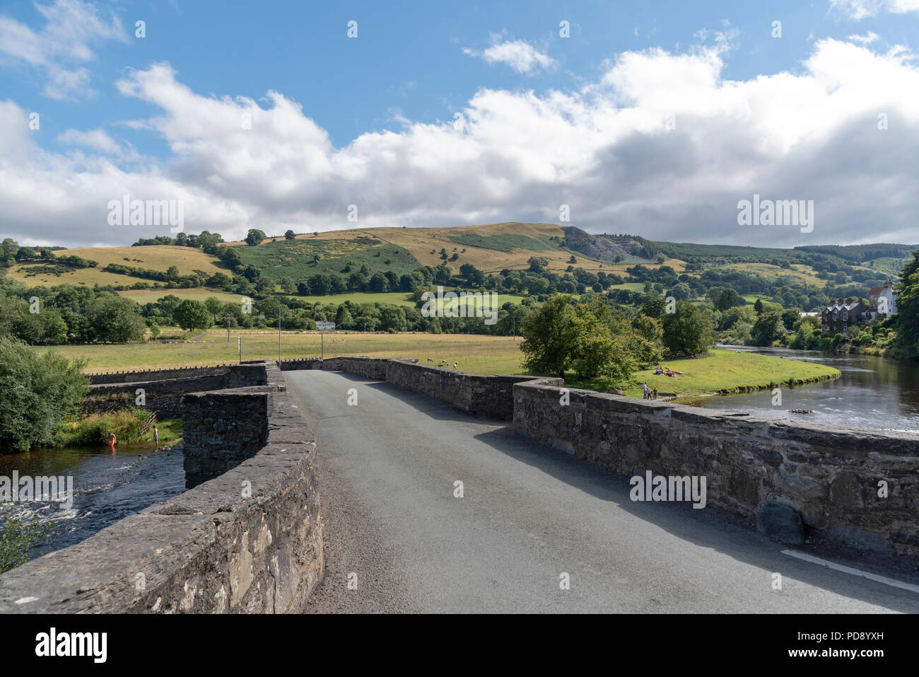 An old stone arched bridge over The River Dee flowing through the Vale ...