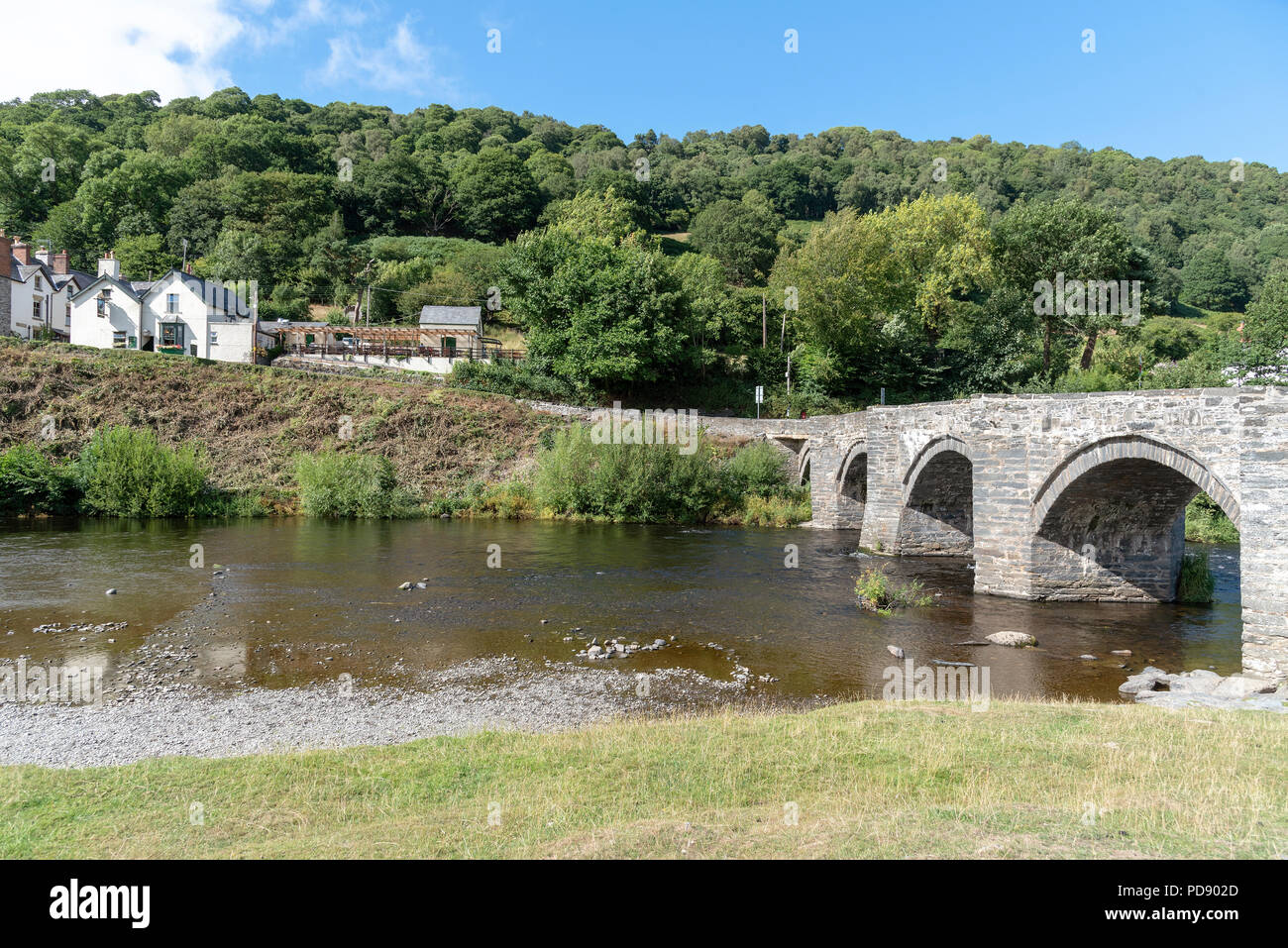 The Grouse Inn and an old stone arched bridge over The River Dee ...