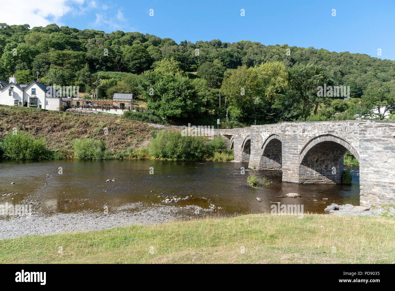The Grouse Inn and an old stone arched bridge over The River Dee ...