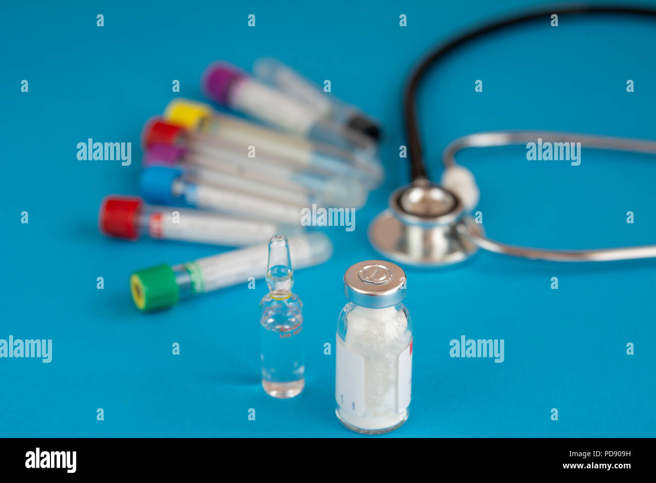 Bottles with medication with several tubes for blood samples at the ...