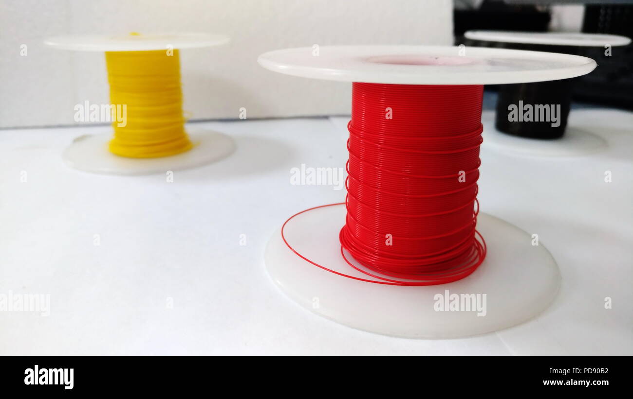 Wire rolls, red, yellow, black Stock Photo - Alamy