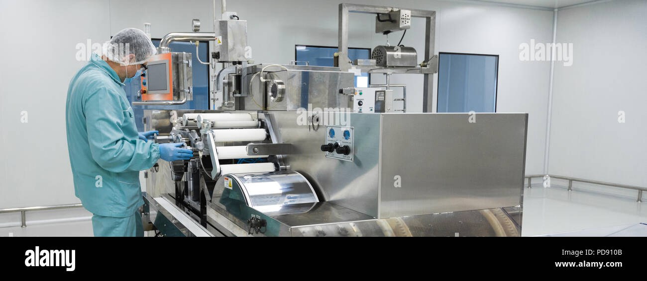 Pharmacy industry factory man worker in protective clothing in sterile ...