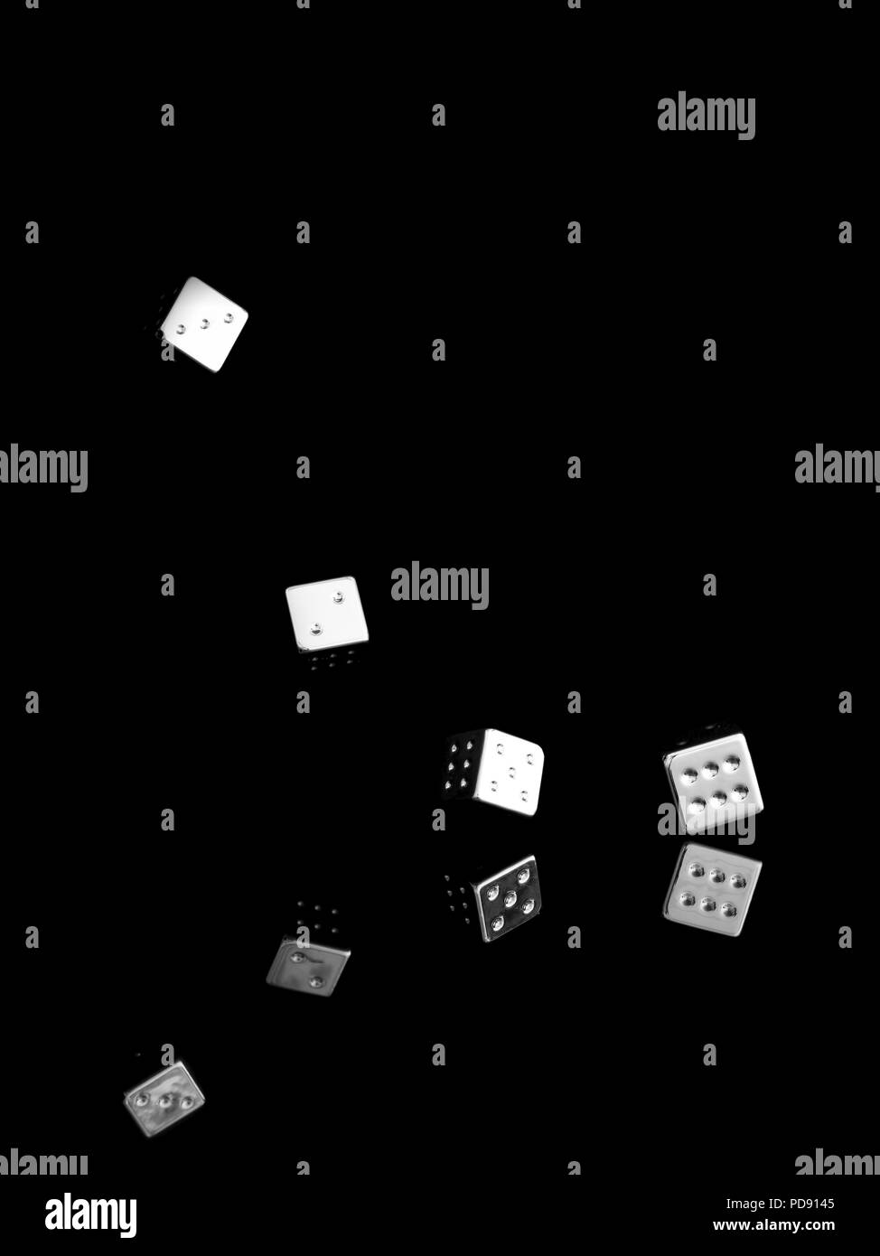 Tumbling shiny dice, on black background. Business concept, success etc ...