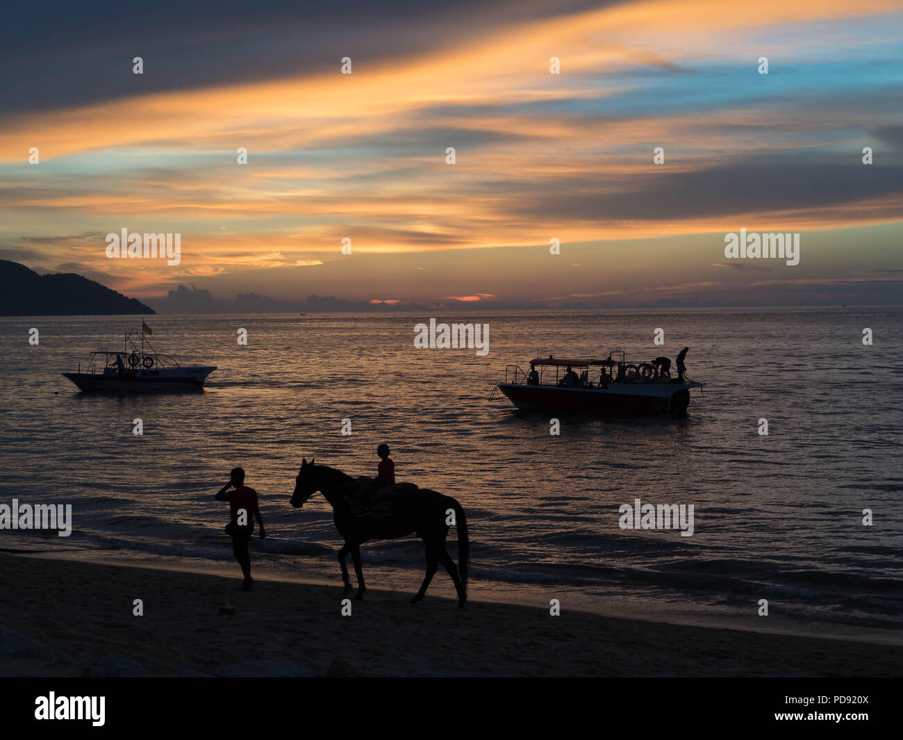 Penang Beach at Sunset with Horse and Boats Stock Photo - Alamy