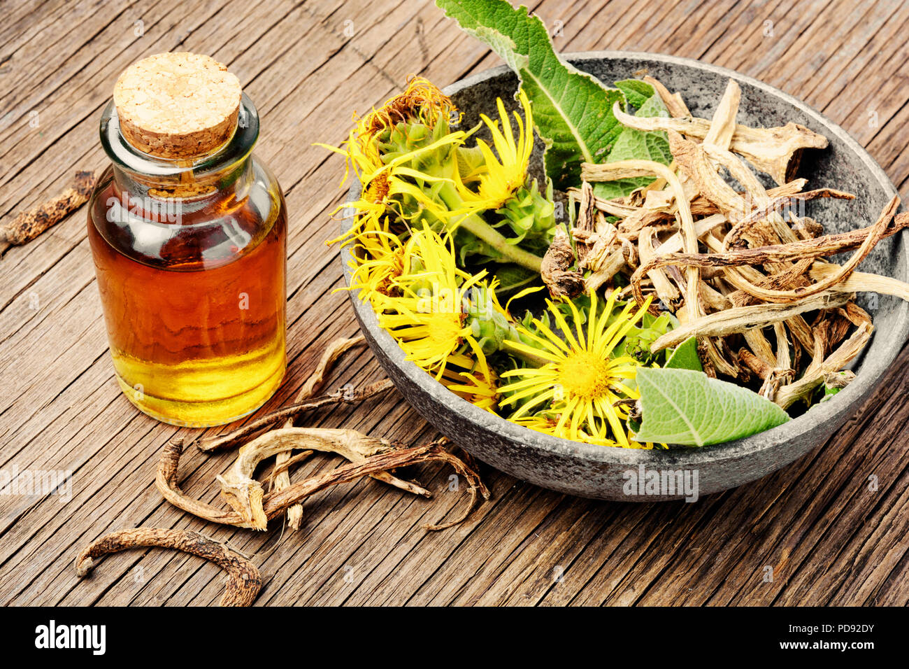Healing elixir from the root of inula.Healing herbs Stock Photo - Alamy