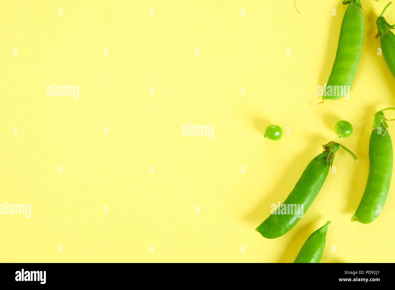 Peas, pods, leaves and pea flowers on a light pastel background. Floral ...