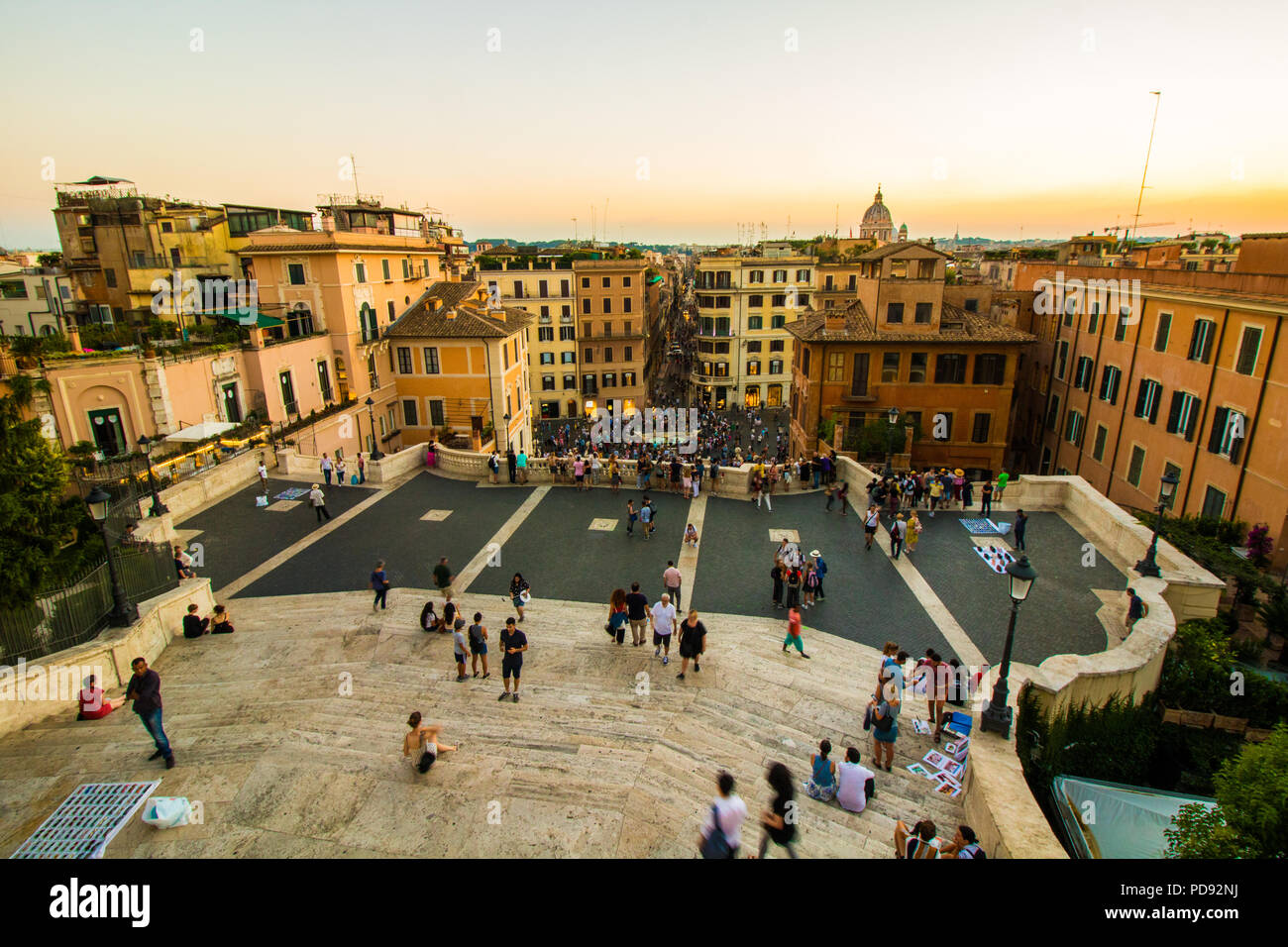 Spanish Steps in Rome at sunset with crowds gathering to enjoy the ...