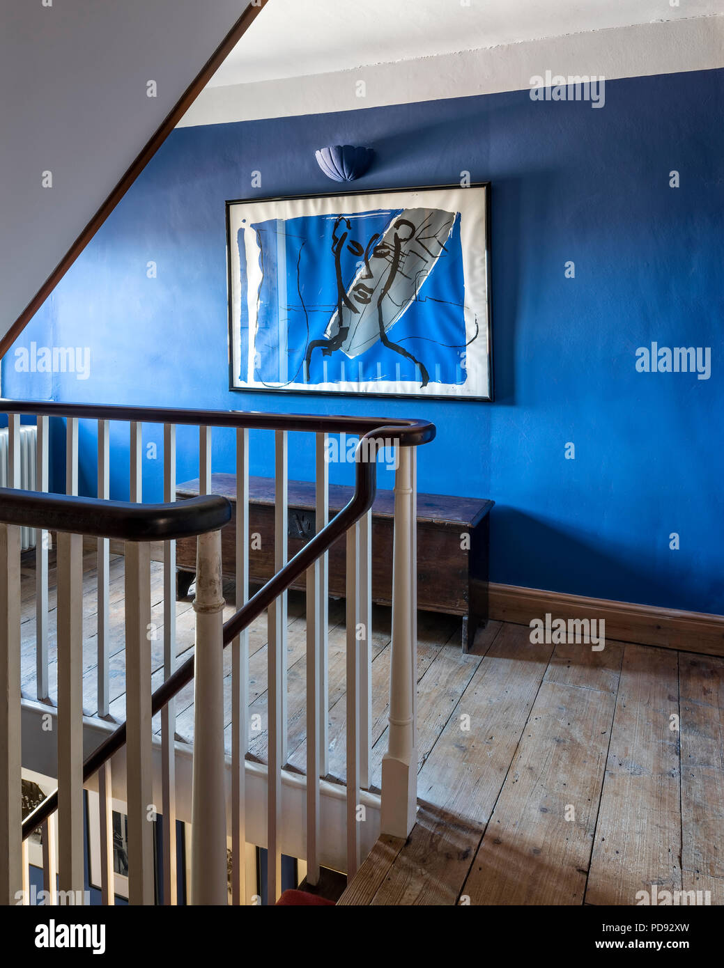 First floor landing with walls painted in strong blue Stock Photo - Alamy
