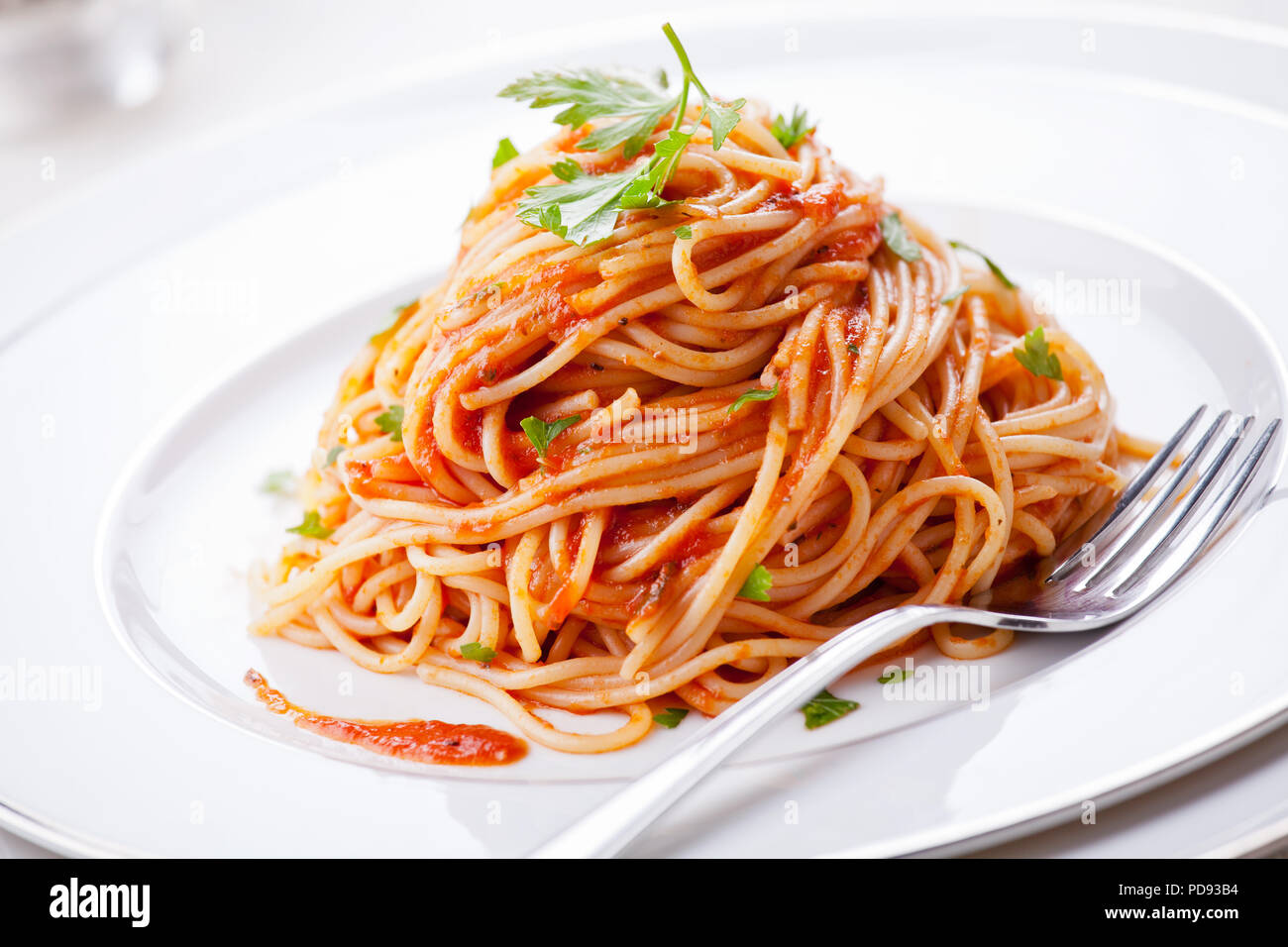 Plate of pasta with homemade tomato sauce and parsley Stock Photo - Alamy
