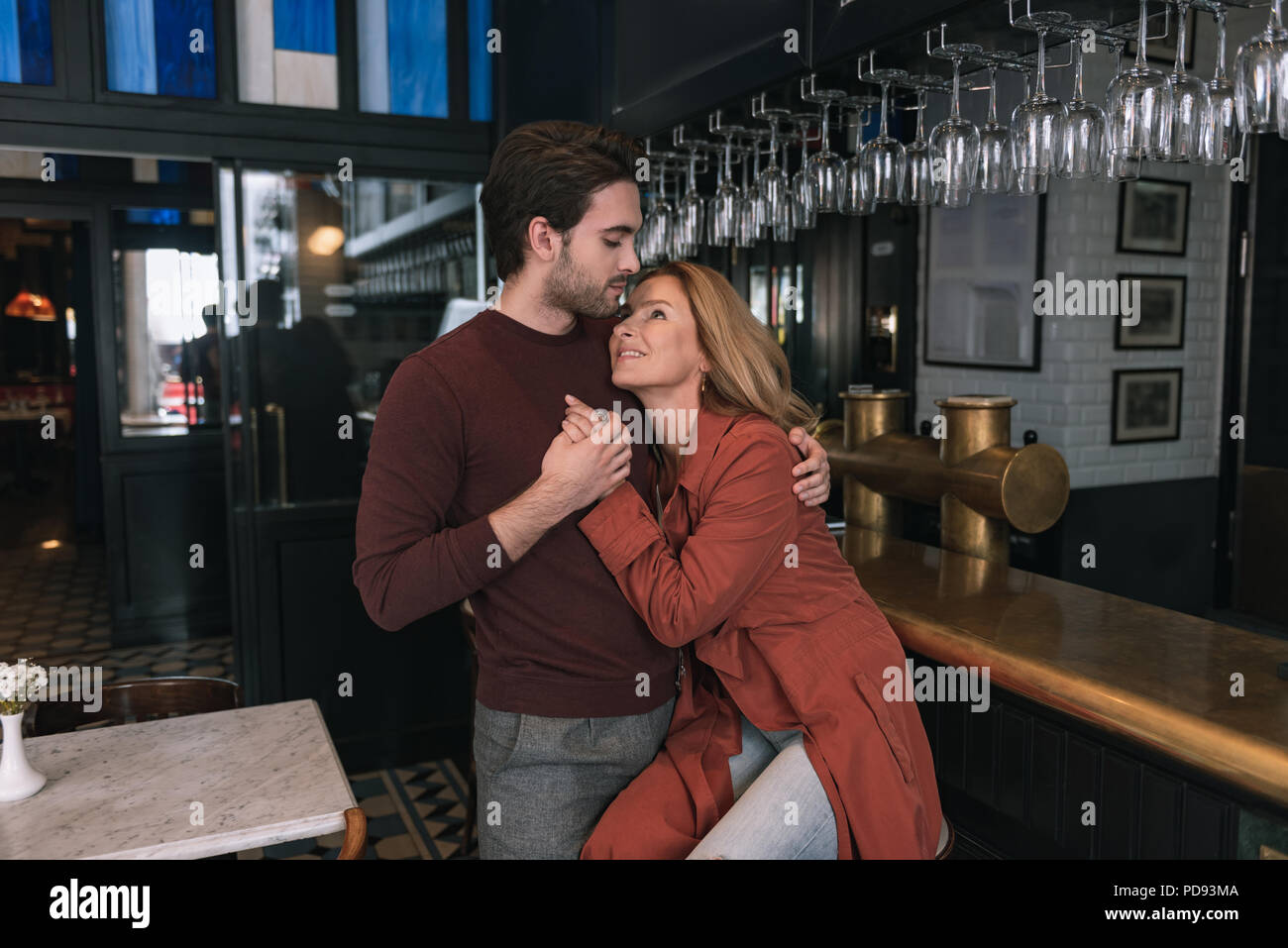 Appealing jolly couple huddling Stock Photo - Alamy