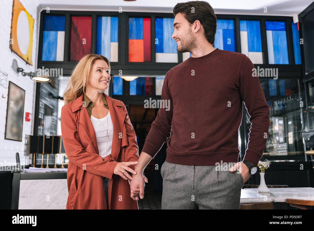 Beautiful appealing woman caressing male hand Stock Photo - Alamy