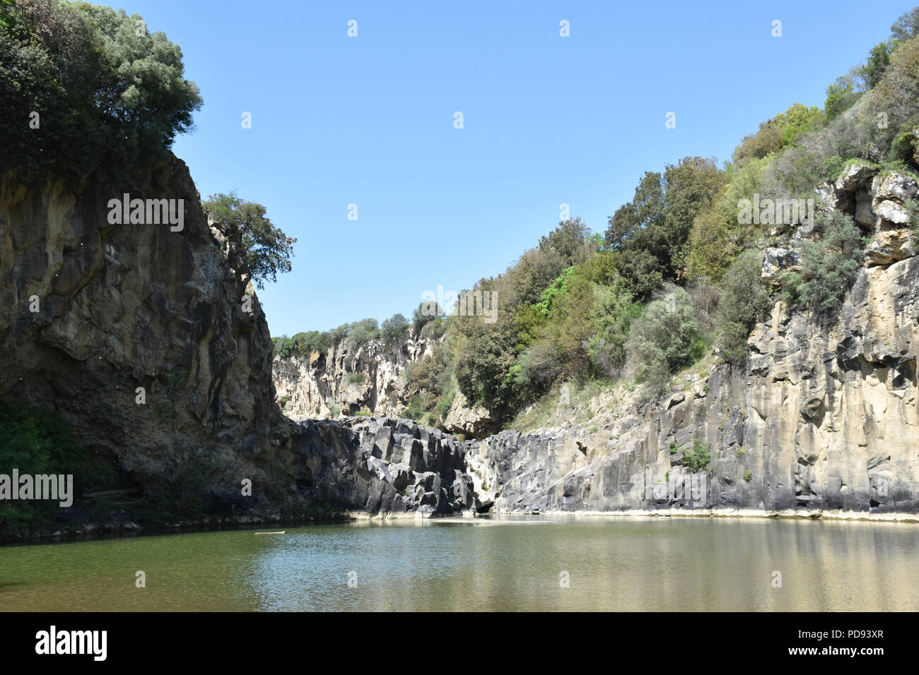 Lake view with stones trees and sky Stock Photo - Alamy