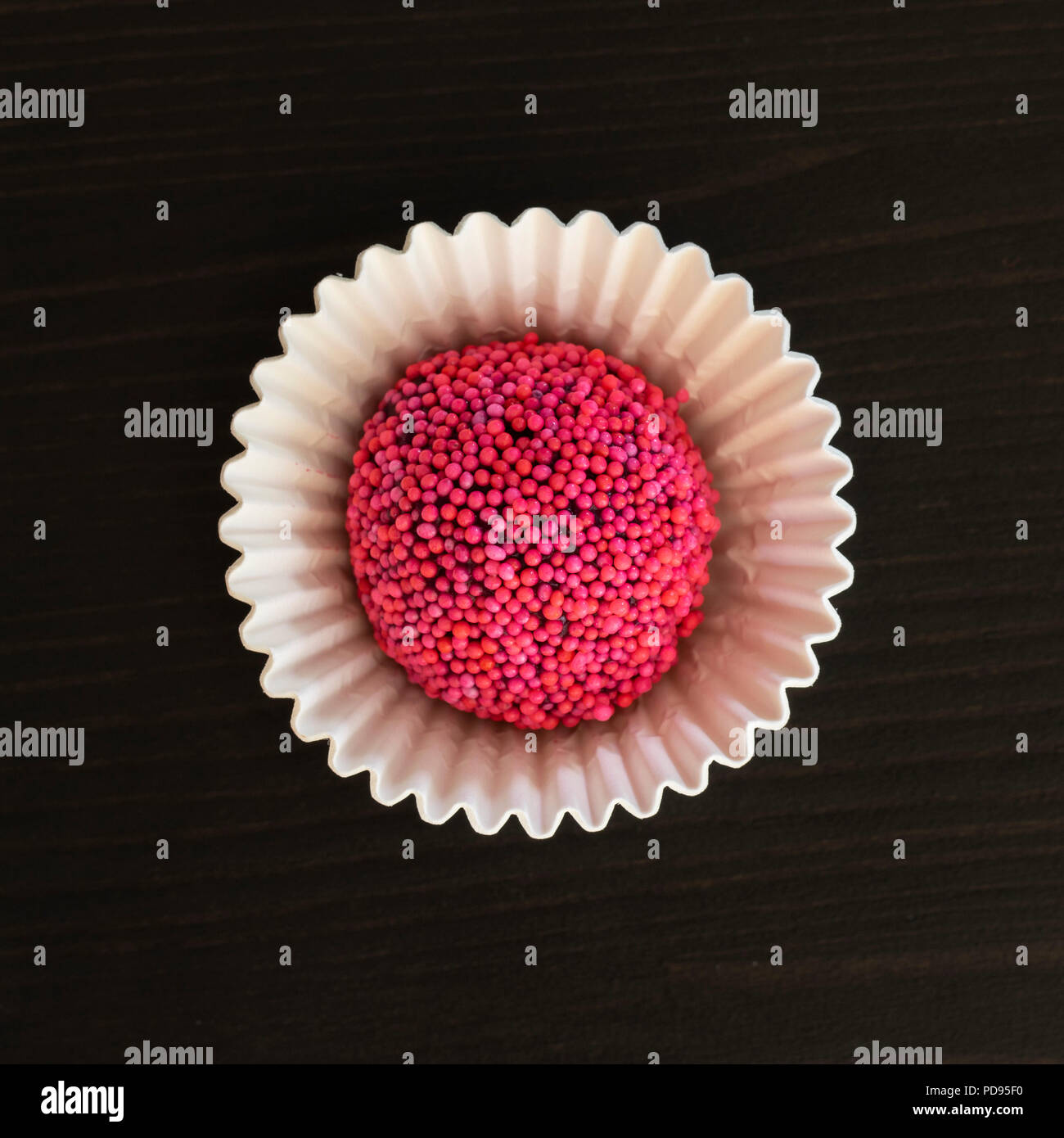 pink red berry brigadeiro brazilian sweet on white paper cup and black ...