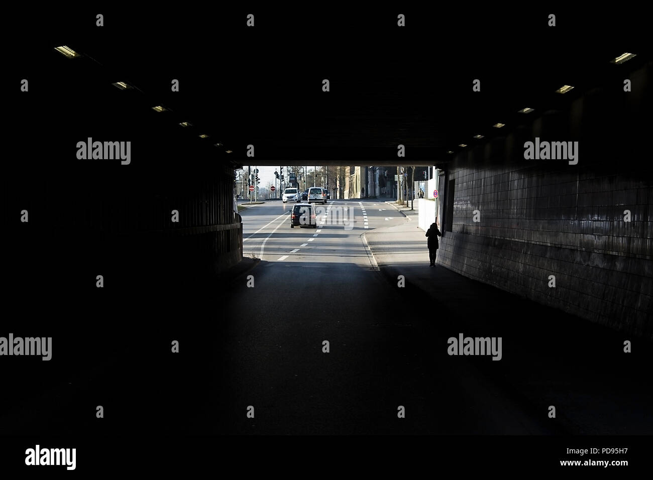 Women silhouette walking through subway underpass next to street Stock ...