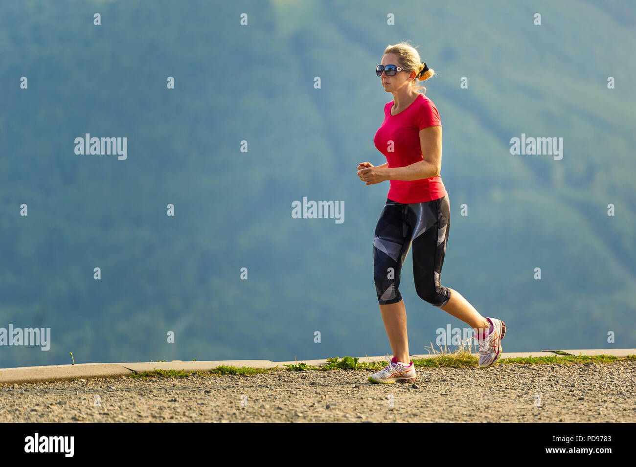 Person running road mountain hi-res stock photography and images - Alamy