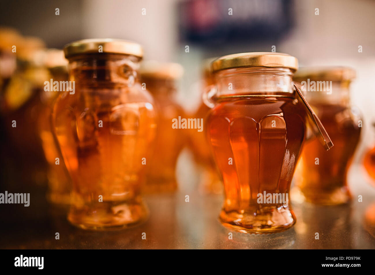 Close up food image of natural honey in little jar on shell on the ...