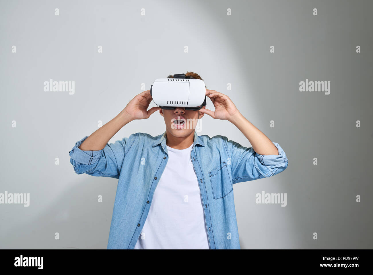 Asian young man wearing virtual reality headset Stock Photo - Alamy