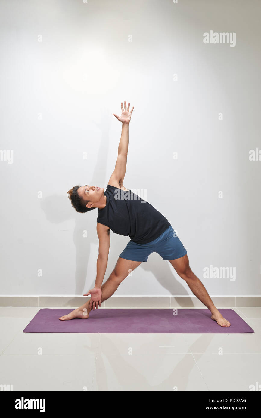 Fitness man plank workout training at white background indoors. Young ...