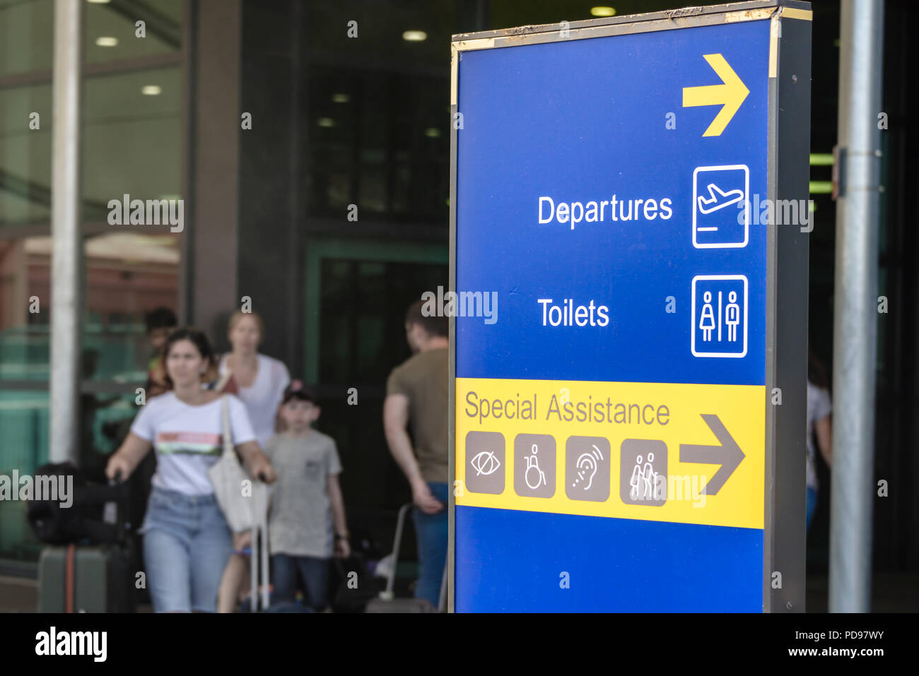 Sign at the entrance of an airport showing passengers where they can ...