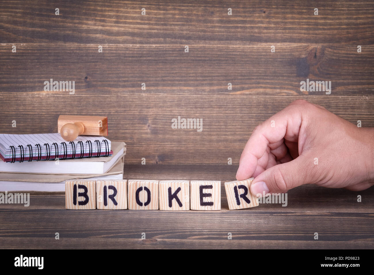 broker. wooden letters on the office desk Stock Photo - Alamy