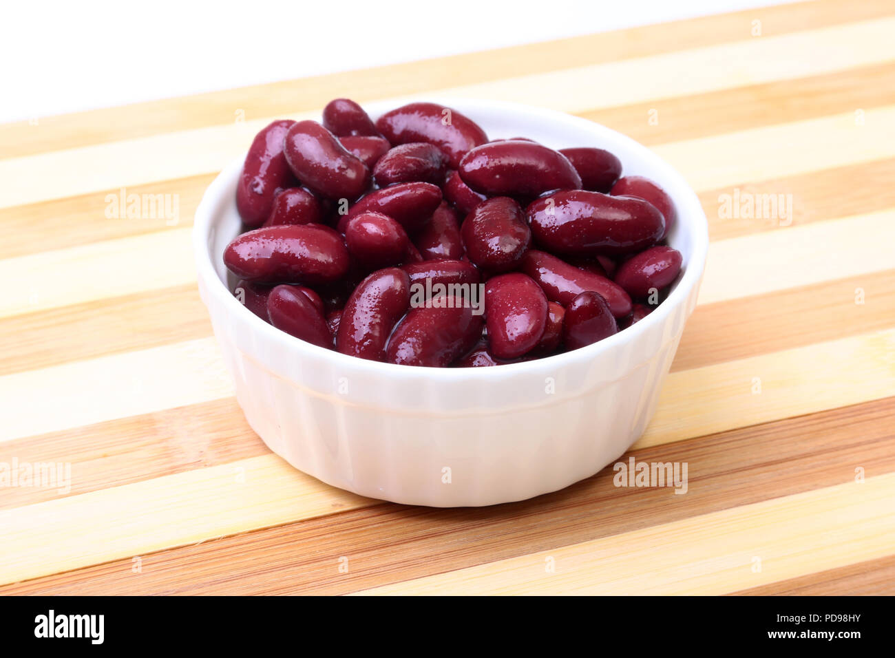 Heap of canned red kidney beans in the sauce in white bowl. vegetarian ...