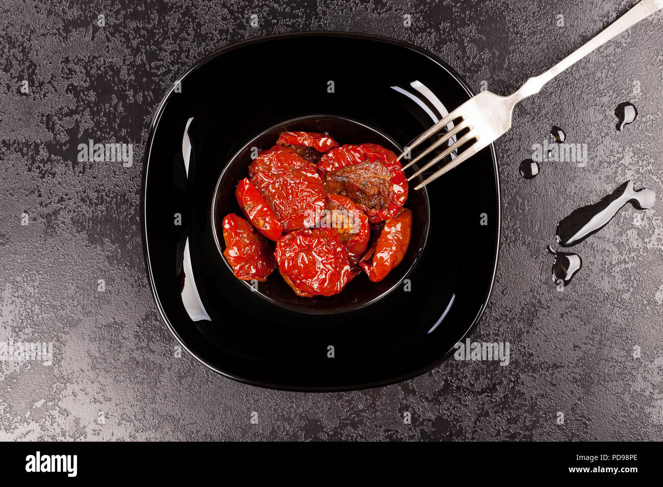 Homemade sun dried tomatoes on plate from above Stock Photo - Alamy