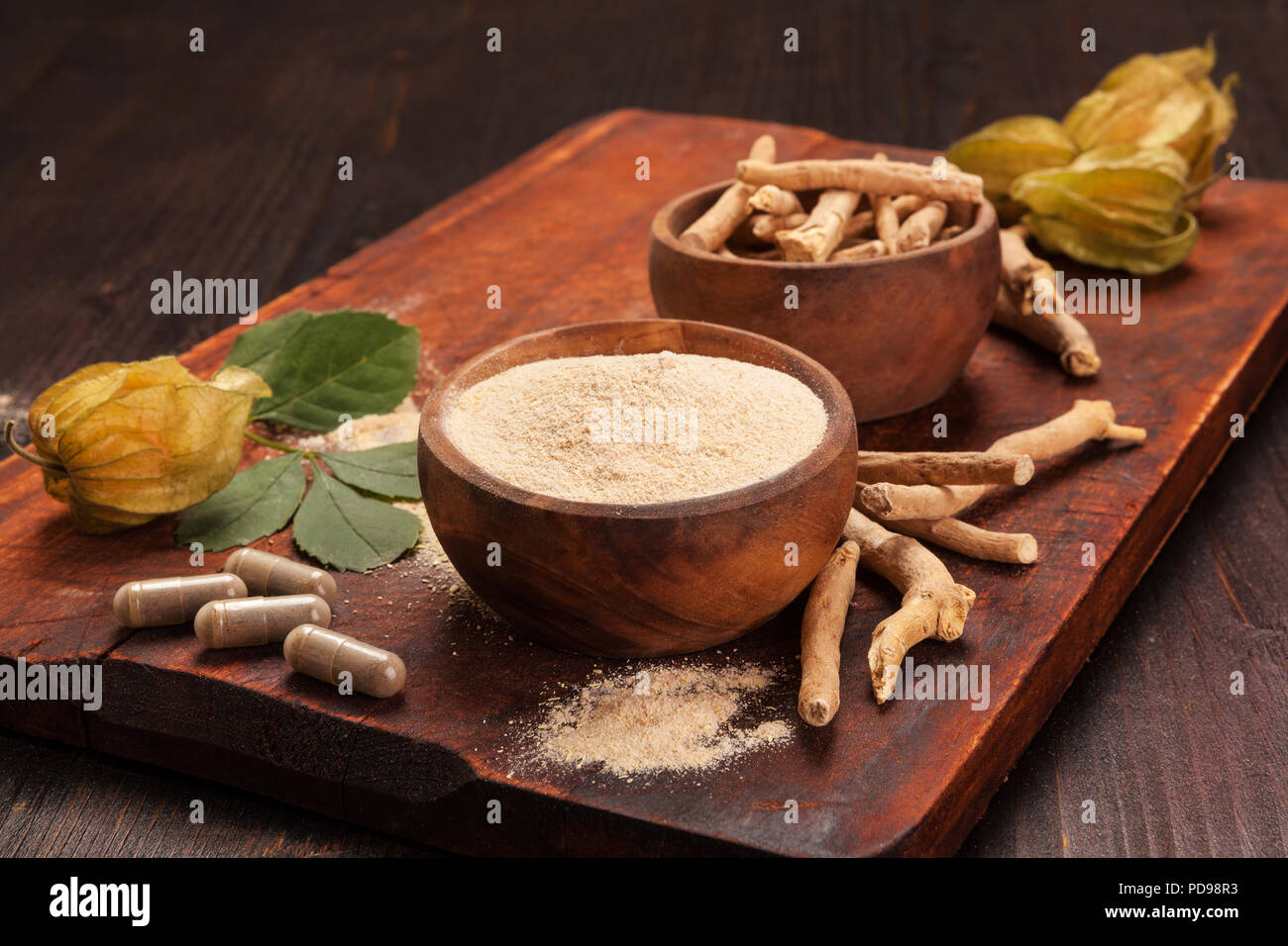 Roots and powder of Ashwagandha also known as Indian ginseng on wooden ...