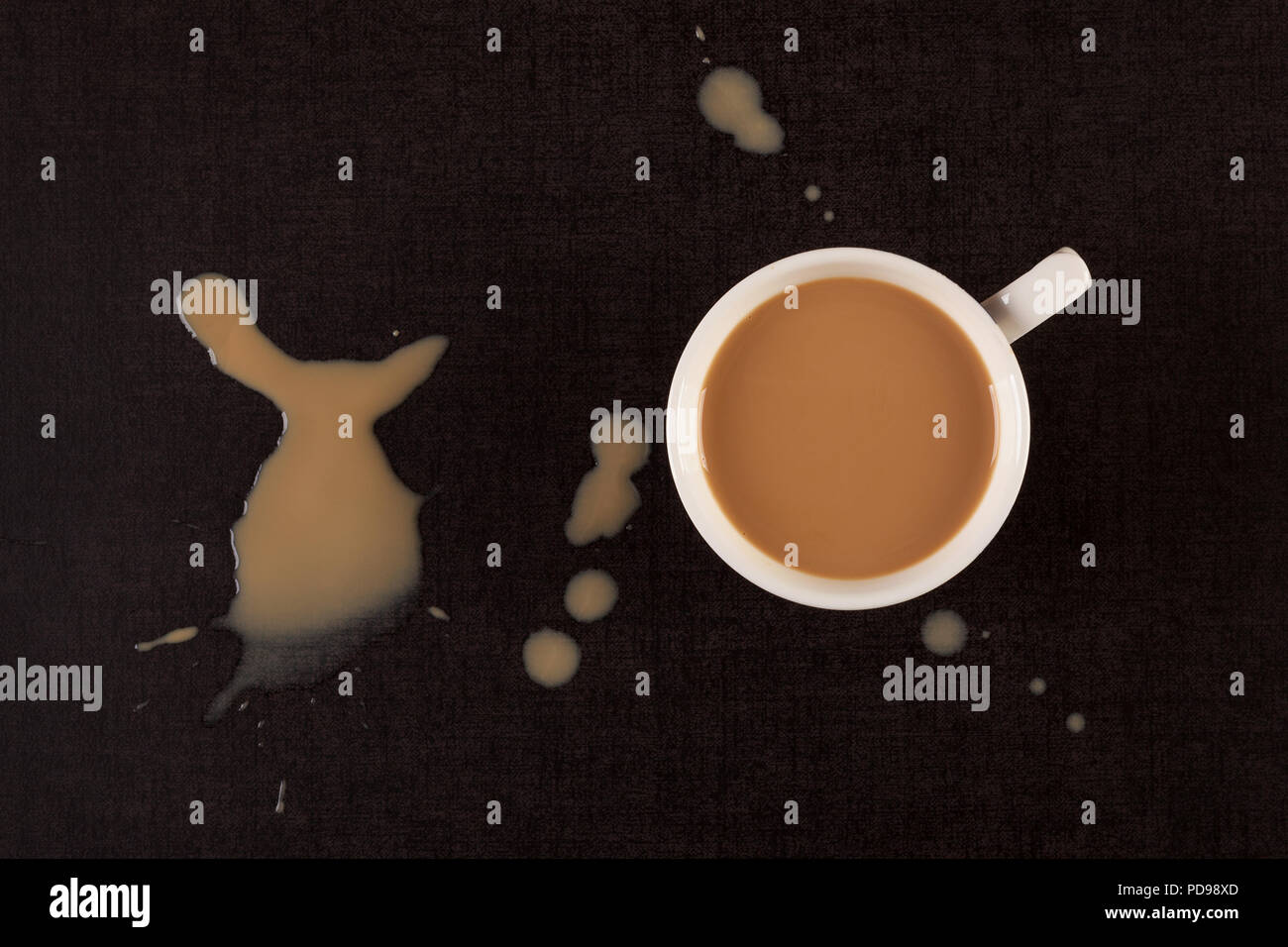 Coffee cup and spilled coffee on a dark background from above Stock ...