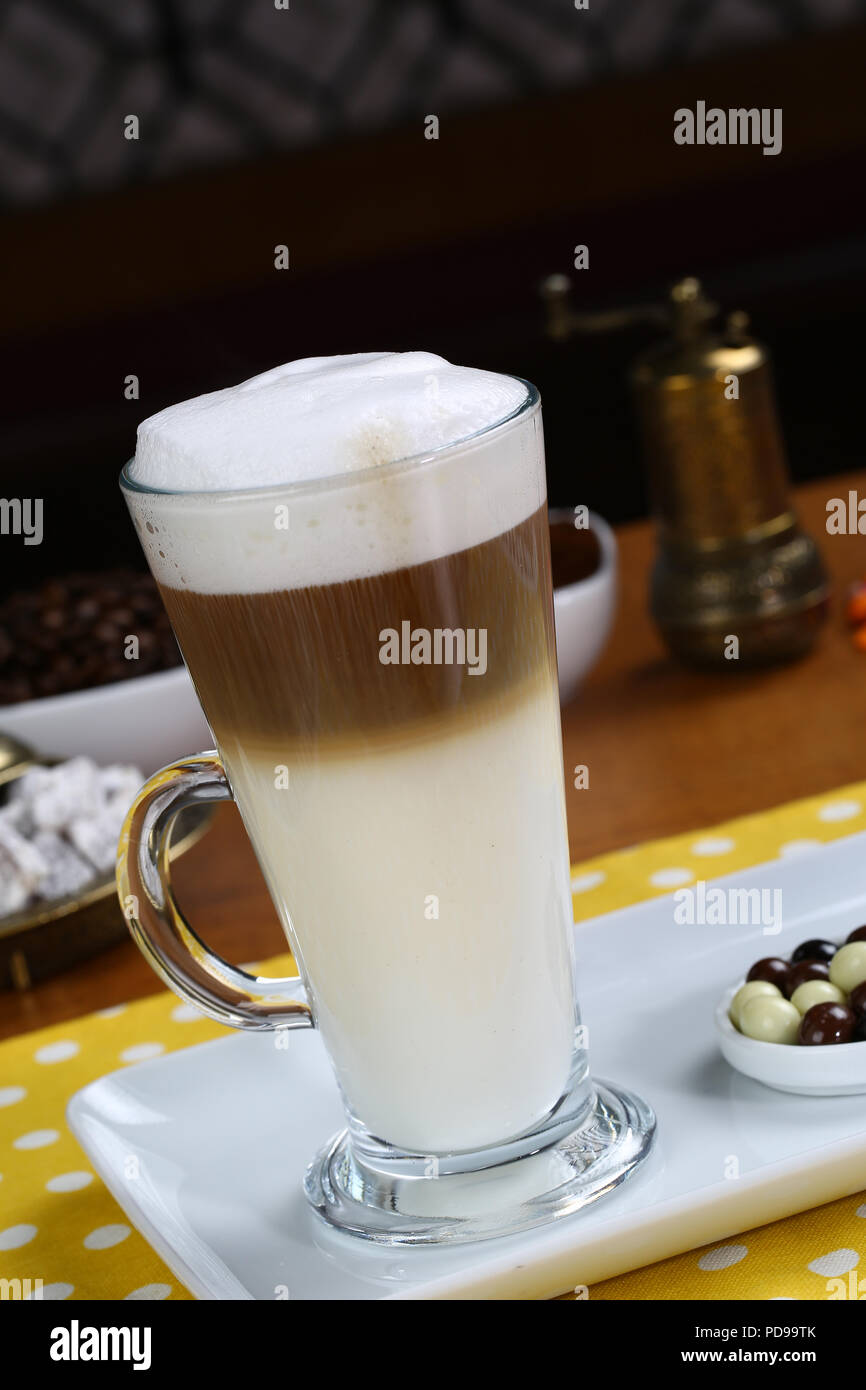 Latte macchiato with whipped cream, serving silver spoon Stock Photo ...