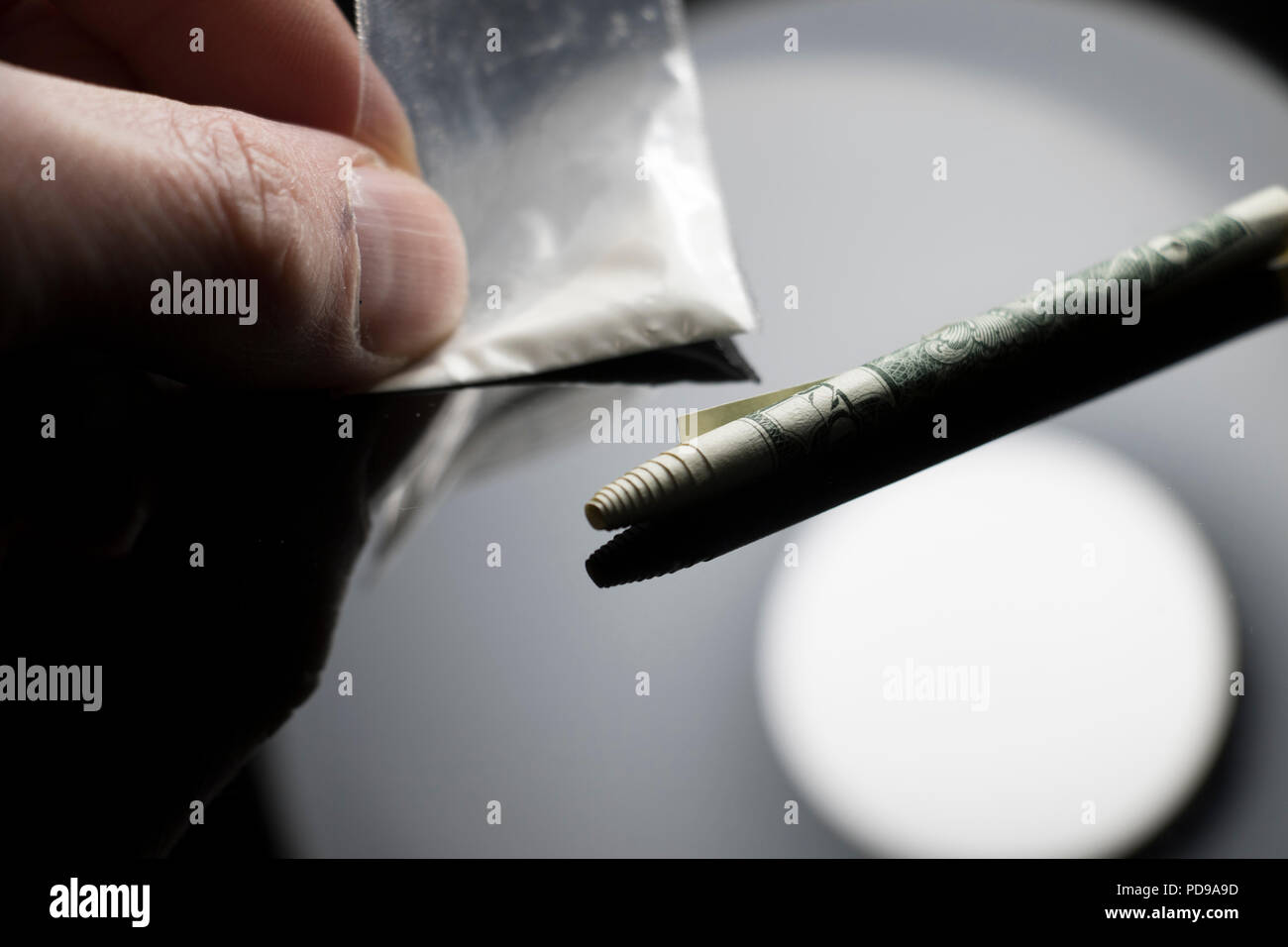 Coke baggie and bill. Small bag of cocaine and rolled money. Party ...