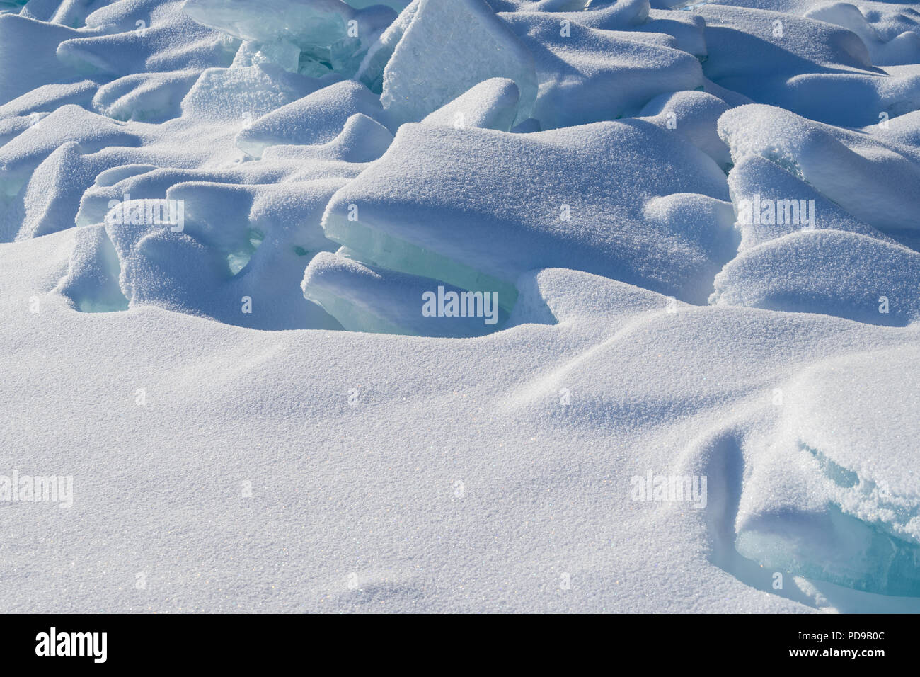 Blue frozen water covered with snow at Baikal lake during winter Stock ...