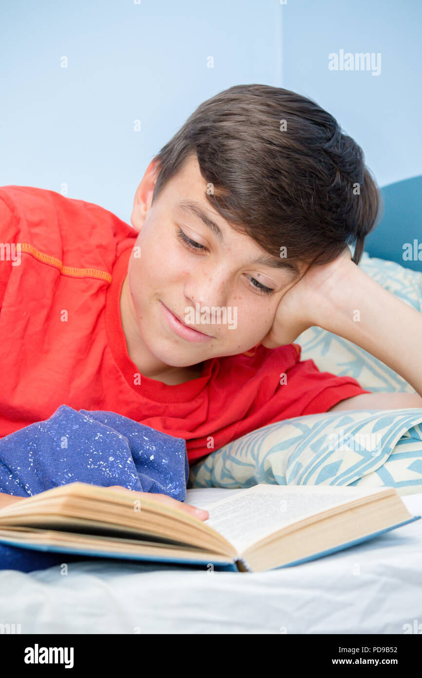 Boy laughing reading book hi-res stock photography and images - Alamy
