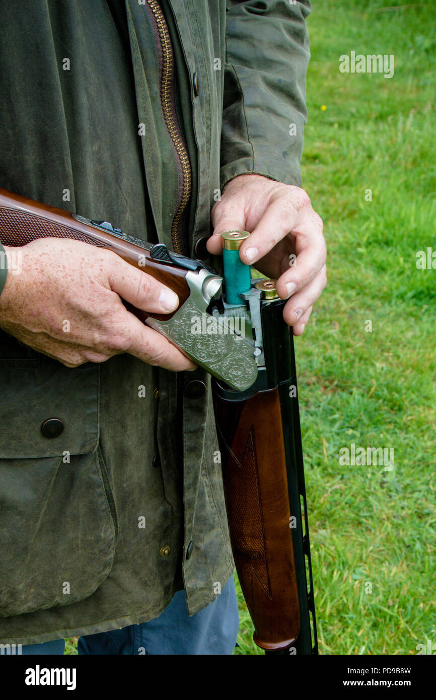 Loading a double barreled shotgun with new cartridges Stock Photo - Alamy