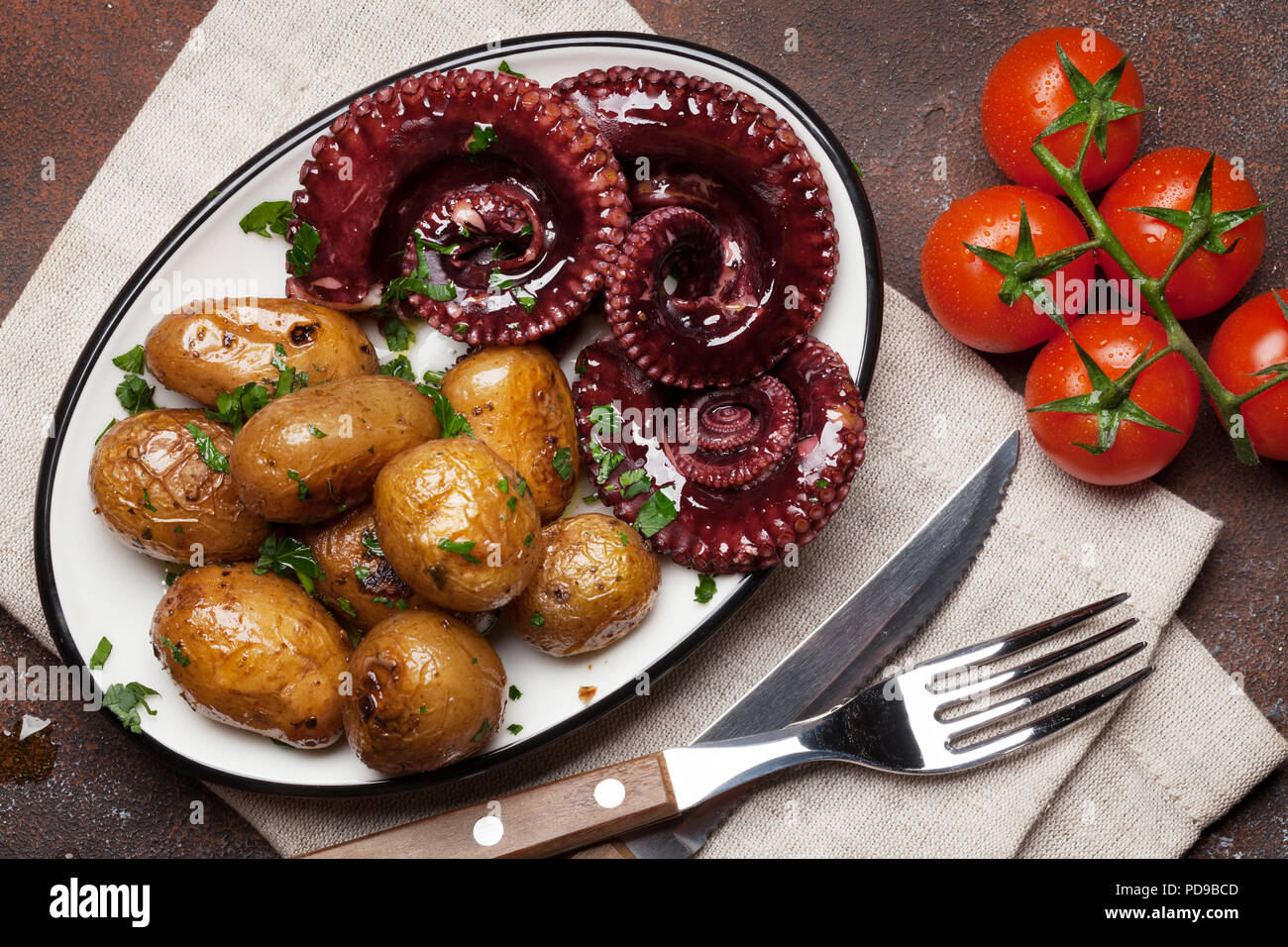 Grilled octopus with small potatoes with herbs and spices. Top view ...