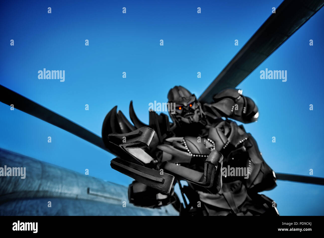 Blurred metallic transformer looking at camera standing near military ...