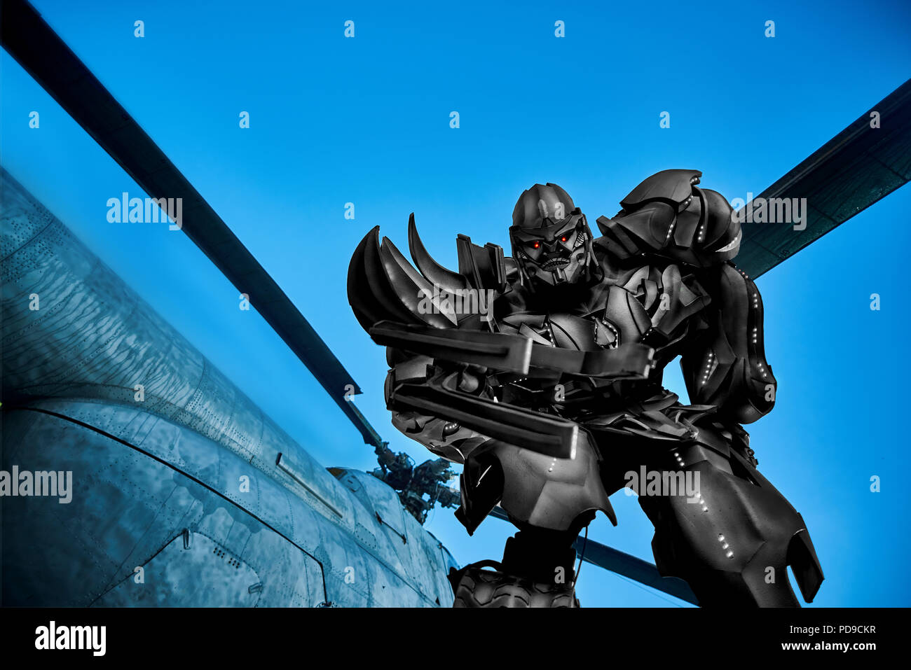 Dangeroud robot-transformer keeping hand, looking at camera. Looking ...