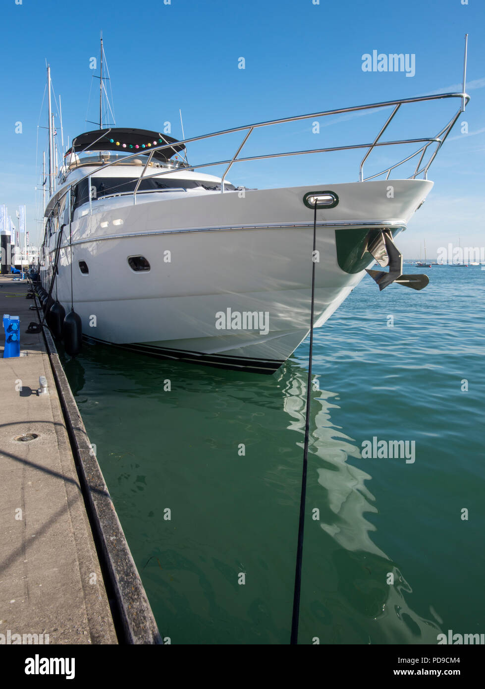 a large motorboat or luxury motor yacht moored on a pontoon at cowes on ...