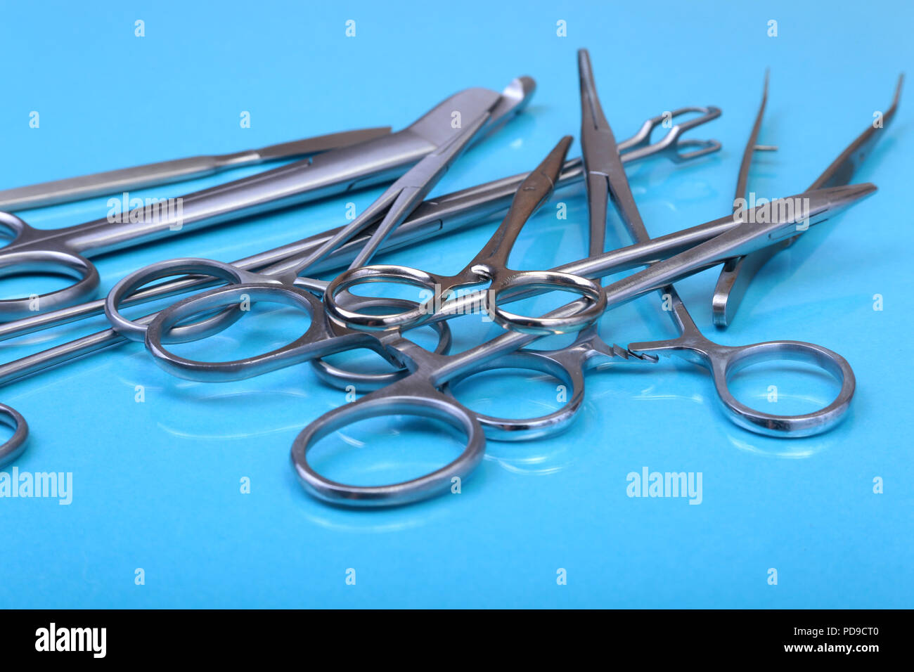 Close Up Surgical instruments and tools on blue mirror background ...