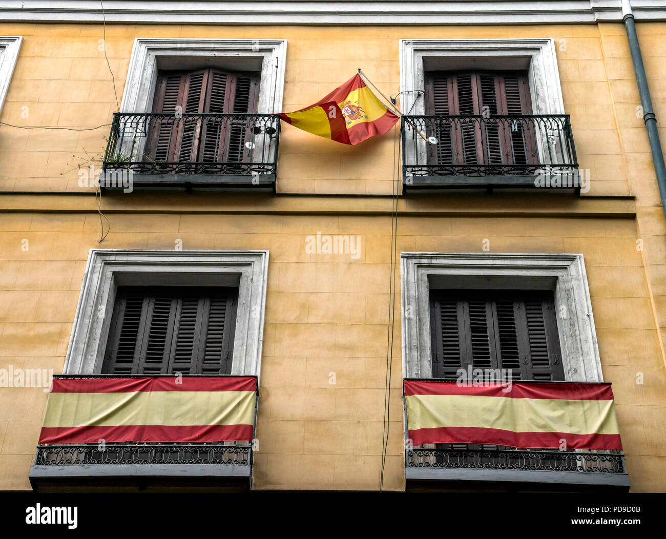 Typical building facade with flags in balconies in Madrid, Spain Stock ...