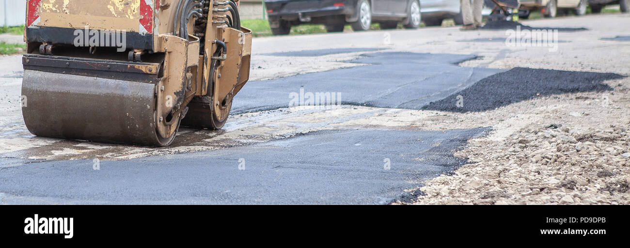 Road roller makes the paving.Close view on the road roller working on ...