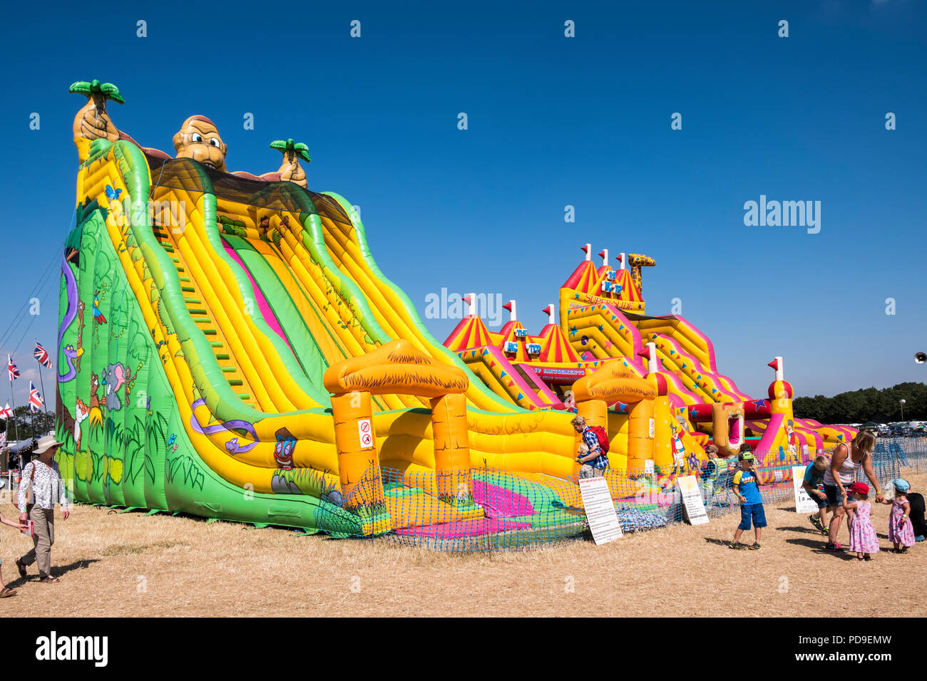Giant Inflatable slides at a country fair Stock Photo - Alamy