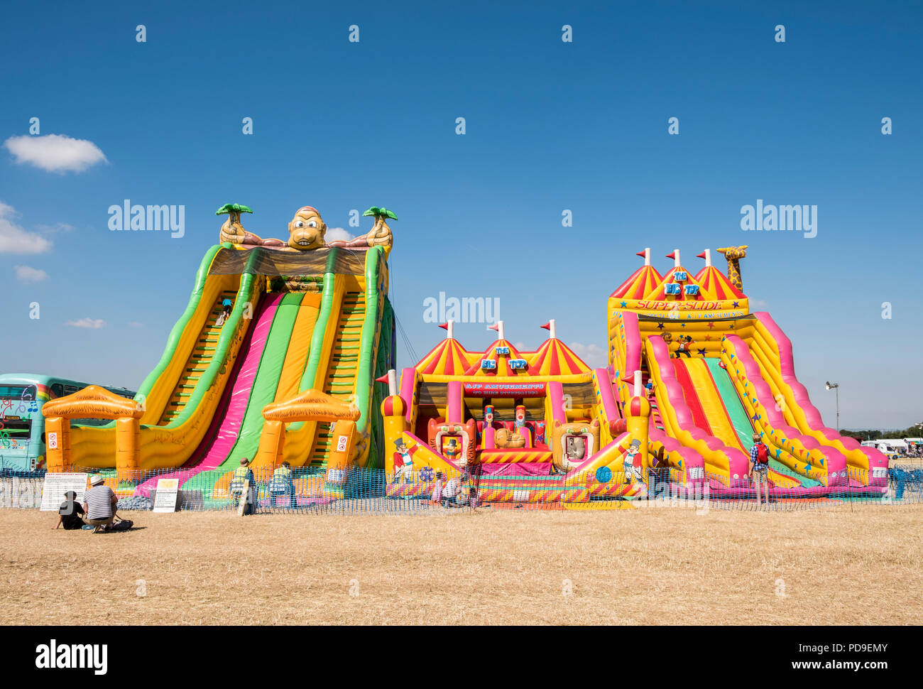 Giant Inflatable slides at a country fair Stock Photo - Alamy
