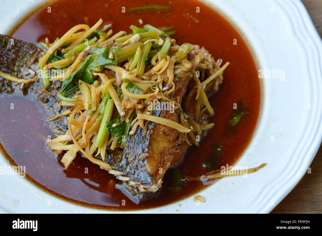deep fried fish in ginger soy sauce Stock Photo - Alamy