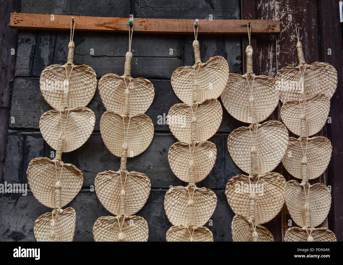 Native fan made from palm leaves at street market in Nanning, China ...