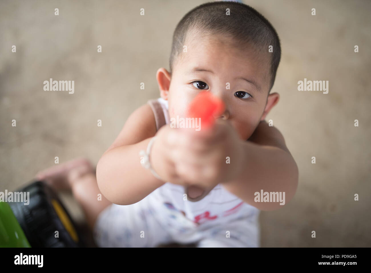 A young child offer his toy to someone Stock Photo - Alamy