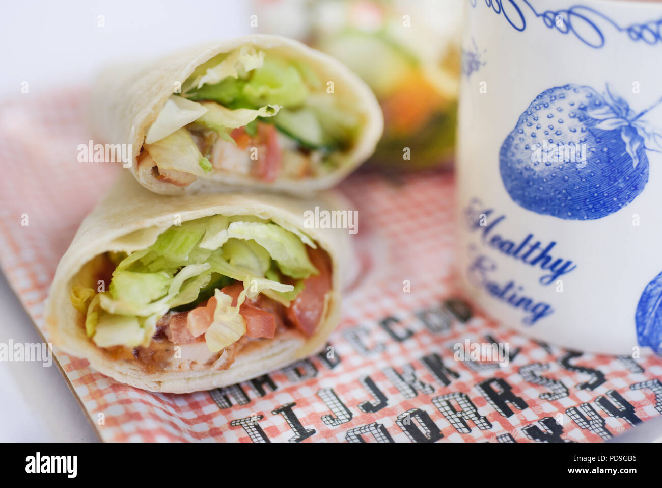 two pieces of salad and chicken wrap on a tray Stock Photo - Alamy