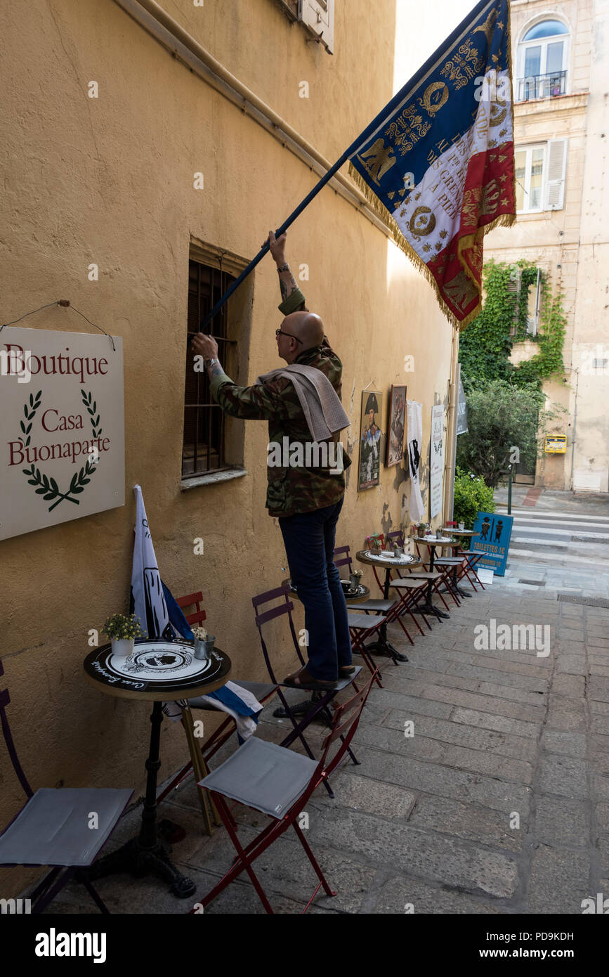 A bartender attaching a replica of Napoleon Bonaparte’s battle flag ...