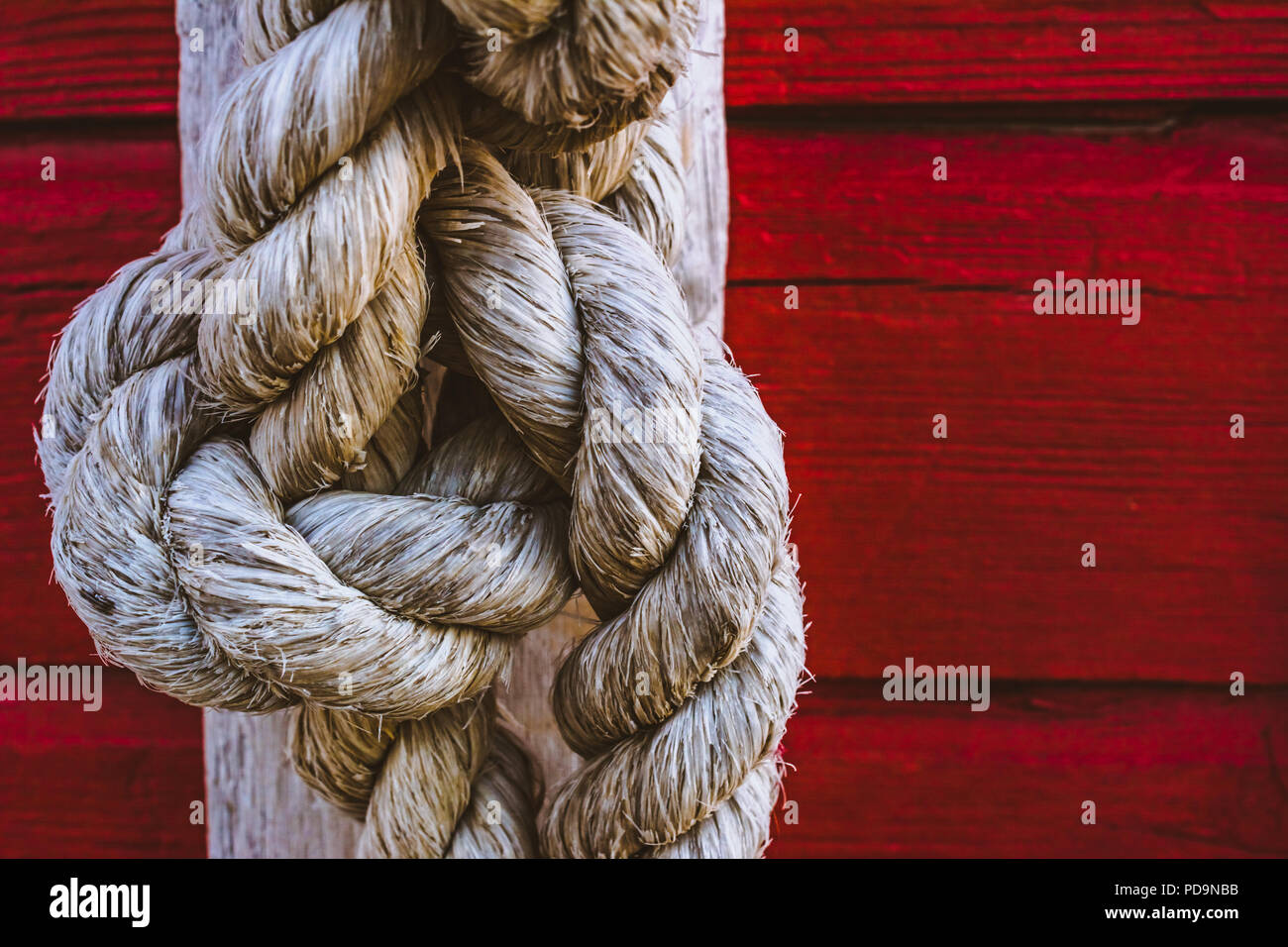 rope knot on deep red wooden background Stock Photo - Alamy